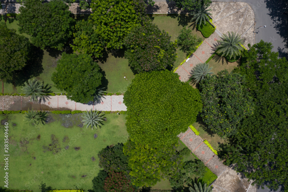 aerial view of modern urban park featuring lakes, lush gardens, bridges ...
