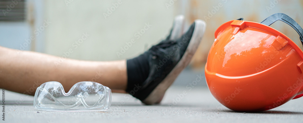 fallen worker on the floor with his helmet, accident injury Stock Photo ...