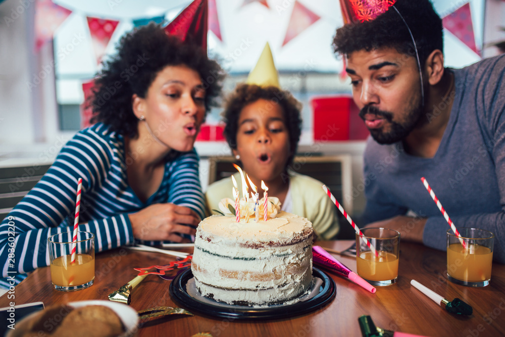 Happy family celebrating a birthday together at home Stock Photo ...