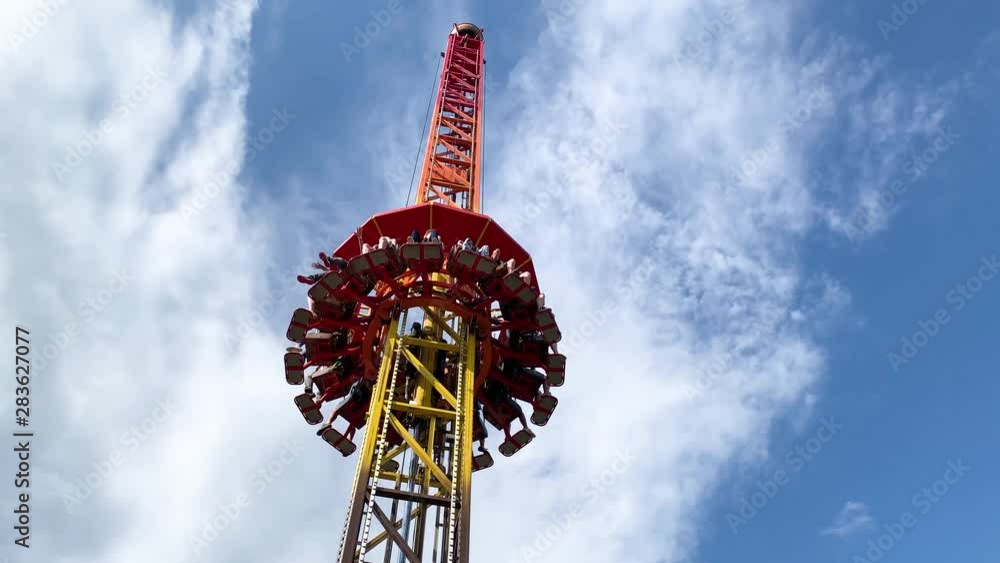 Amusement park, attraction with free fall tower. Stock Video | Adobe Stock
