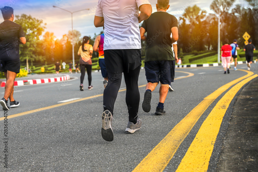 Healthy group of people jogging on track in park. people exercise ...