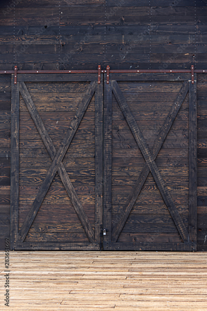large sliding barn doors built with dark wood Stock Photo | Adobe Stock