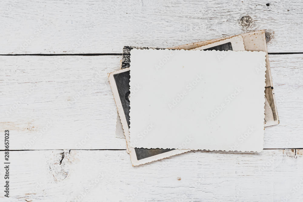 Old photos on white wooden background. Empty photo frame. Stock Photo ...