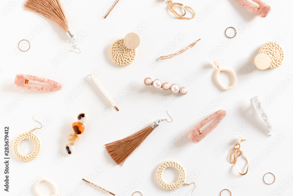 Pattern made of earrings, rings, hairpins on white background Stock ...