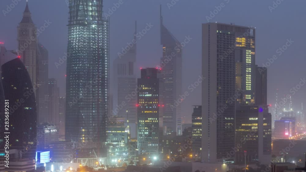 Dubai downtown skyline night to day aerial timelapse with traffic on ...