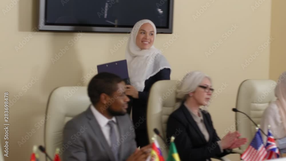 Beautiful muslim woman in hijab walking into conference room and ...