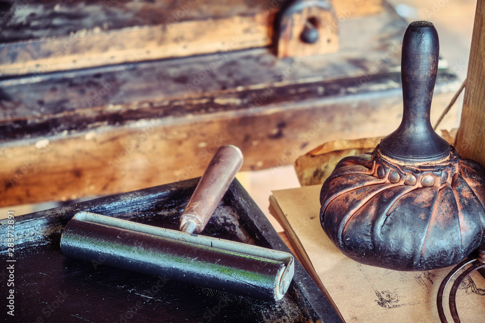 Roller for even distribution of ink on the old printing press. Vintage ...