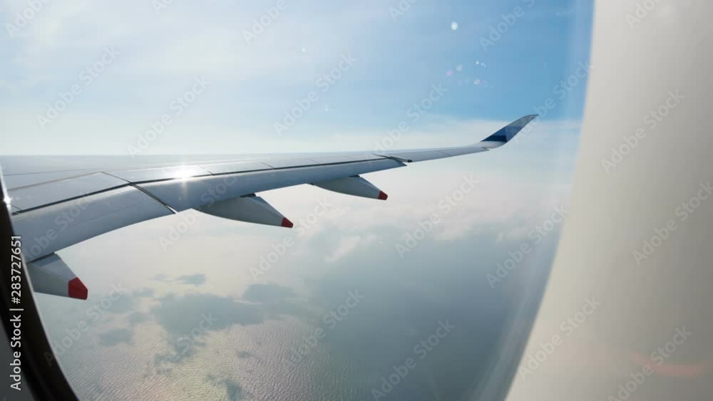 Wideo Stock: Zooming in hyperlapse view trough plane window of jet wing ...