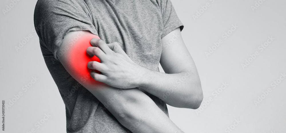 Man scratching his shoulder with rash, panorama Stock Photo | Adobe Stock