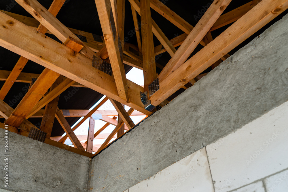 Roof trusses covered with a membrane on a detached house under ...