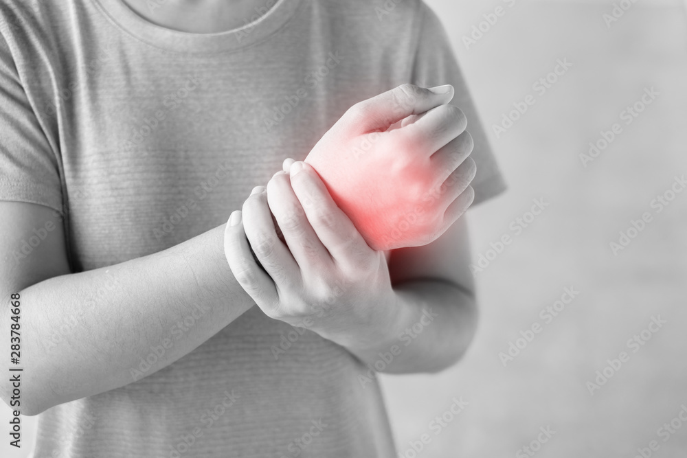 Fototapeta Young woman holding her wrist pain because using computer ... Fototapeta Young woman holding her wrist pain because using computer ...