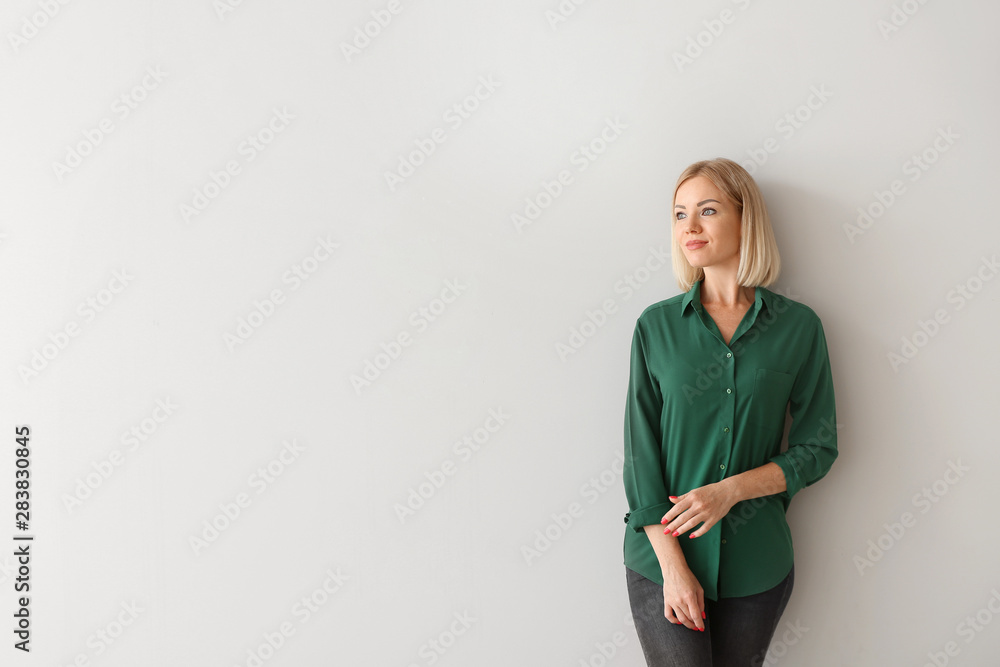 Portrait of beautiful woman on light background Stock Photo | Adobe Stock
