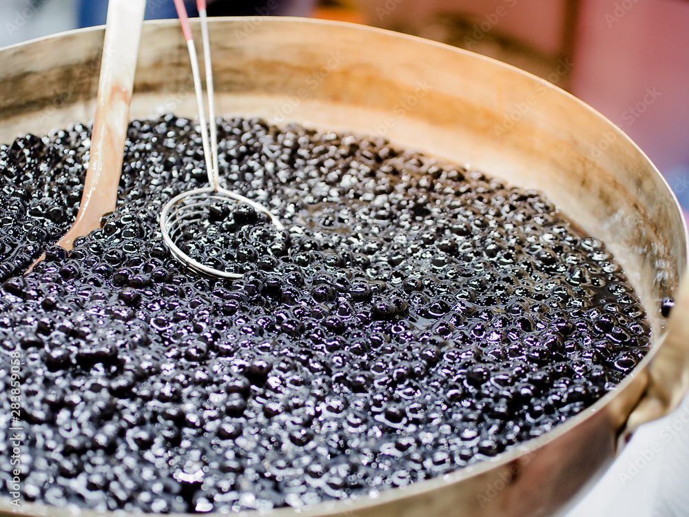 Tapioca ball or boba for bubble tea in brass pan. boba is ingredients ...