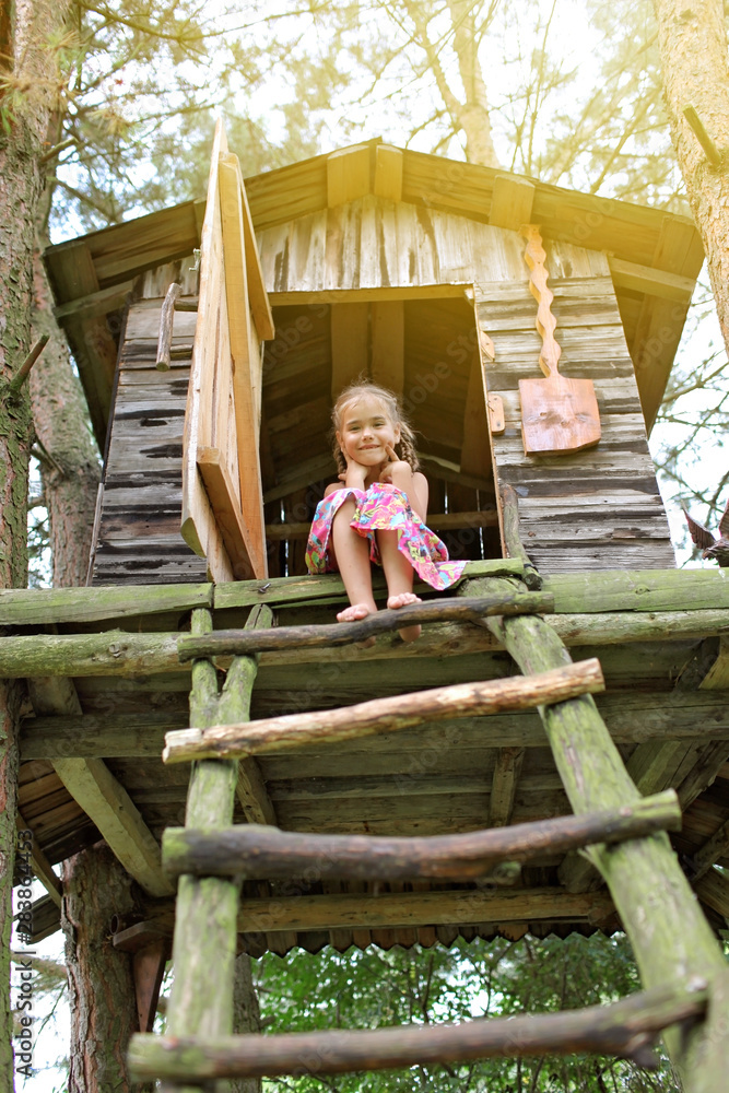 Happy cute kid playing in the treehouse Stock Photo | Adobe Stock