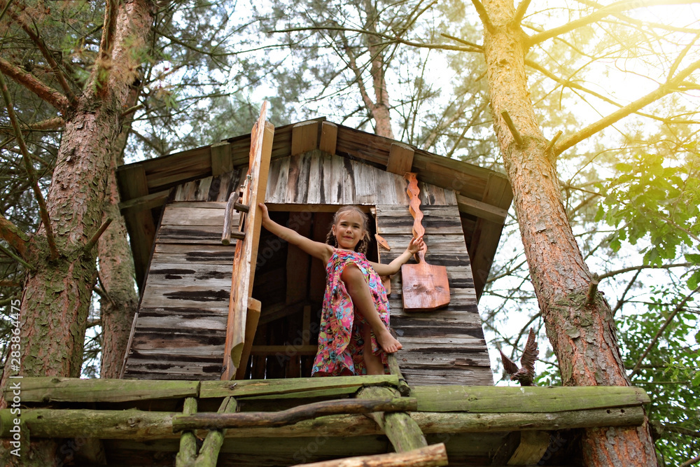 Happy cute kid playing in the treehouse Stock Photo | Adobe Stock