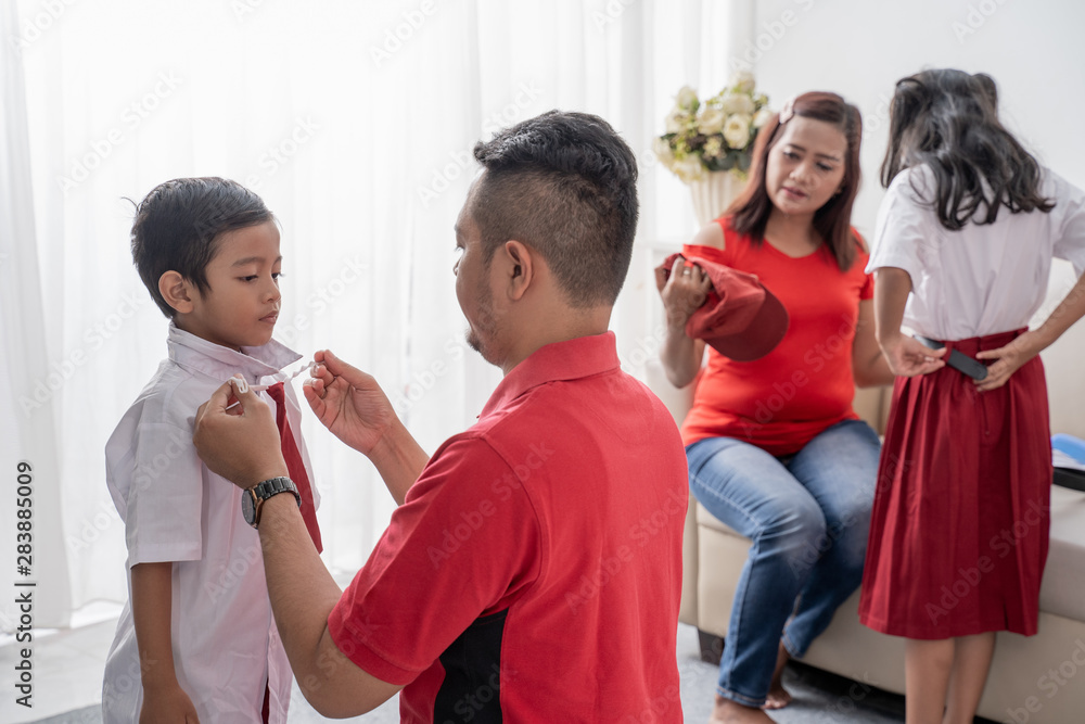 parent help their children getting ready for school. back to school ...