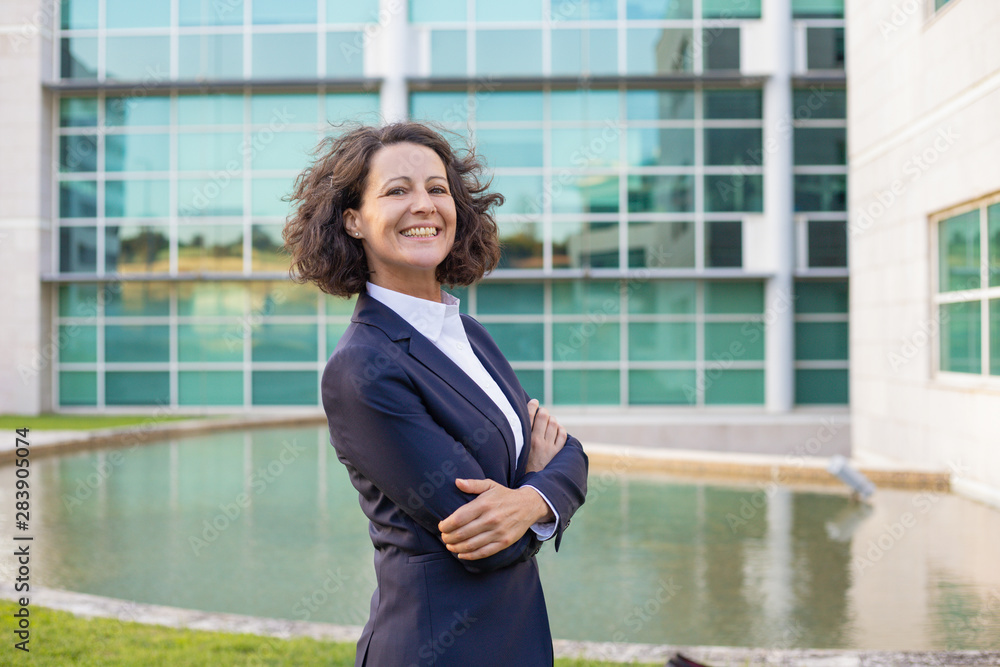 Joyful confident female ceo posing outside. Woman wearing formal suit ...