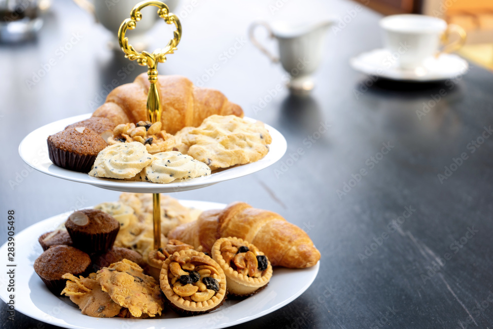 High tea set are on the black table Stock Photo | Adobe Stock