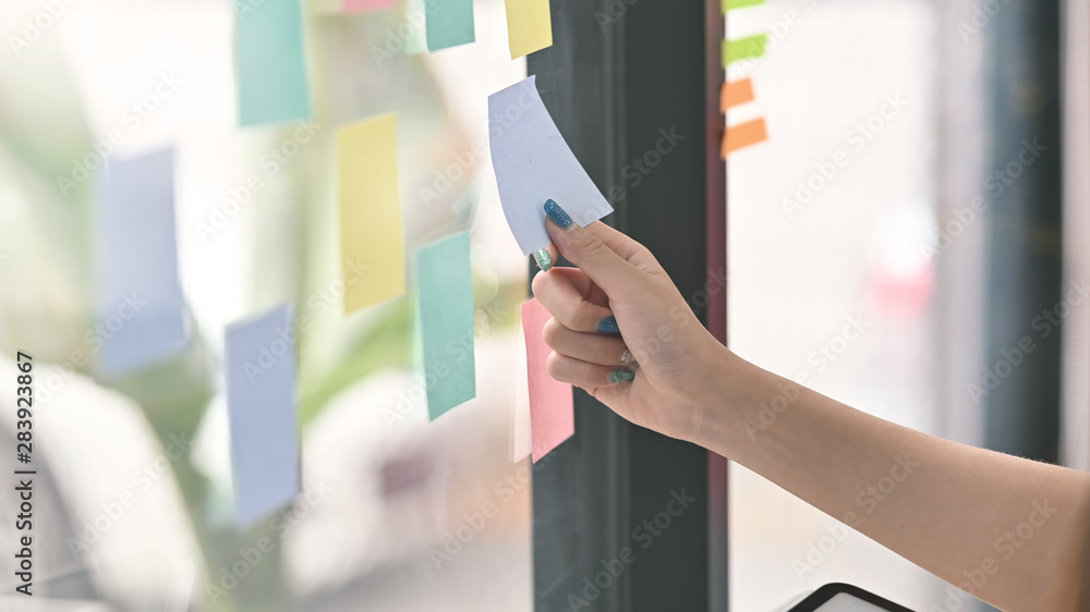 Close-up Sticky note paper reminder schedule board. Business people ...