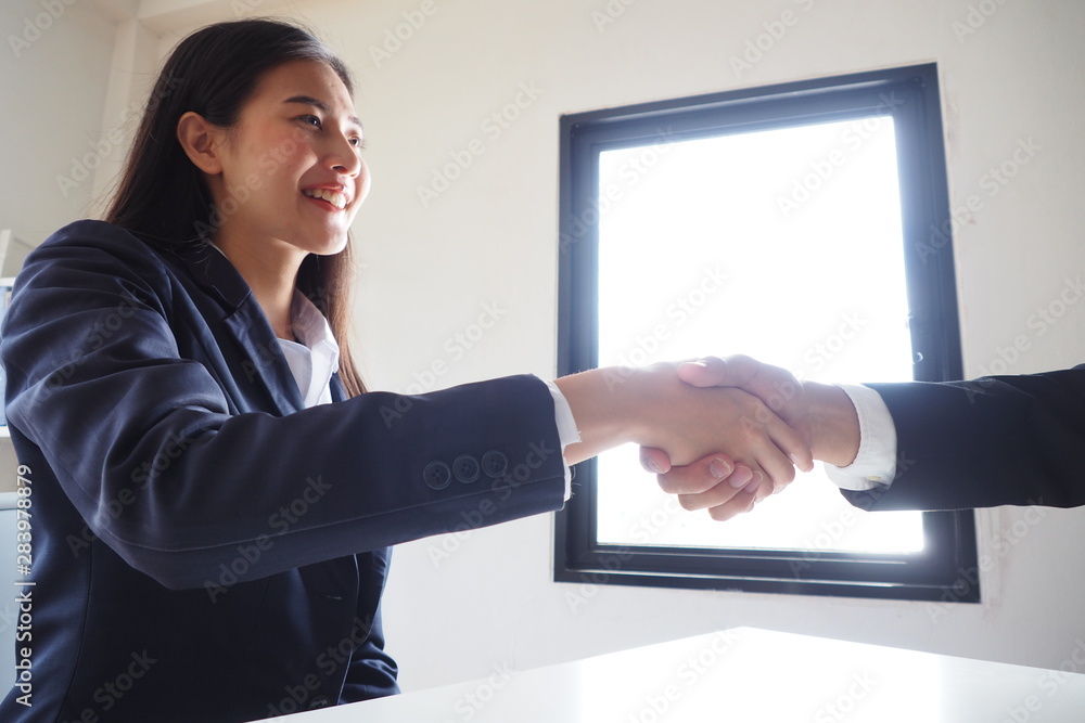 Young female graduate shaking hand with employer after passing job ...