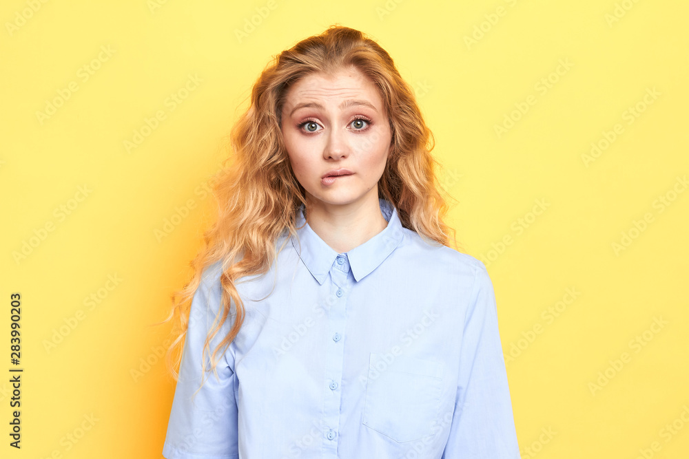 Shy and timid woman having indecisive confused look while answering to ...