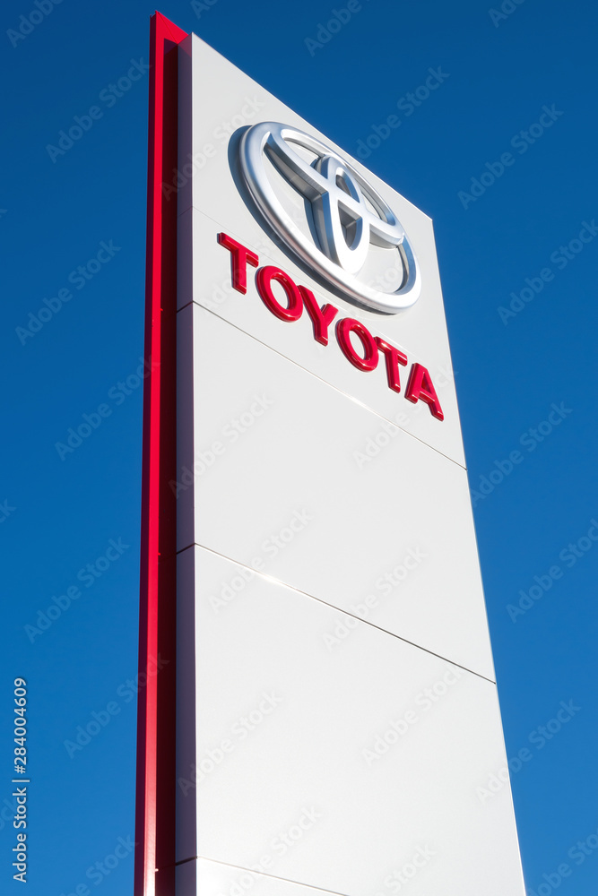 COLOGNE, GERMANY - August 25, 2016: Toyota dealership sign against blue ...