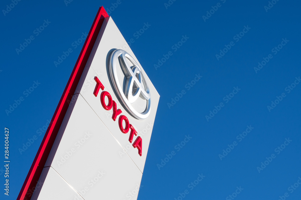 COLOGNE, GERMANY - August 25, 2016: Toyota dealership sign against blue ...