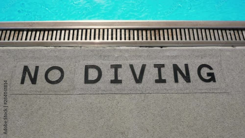 'No Diving" warning sign on the ground by a swimming pool. Caution sign ...