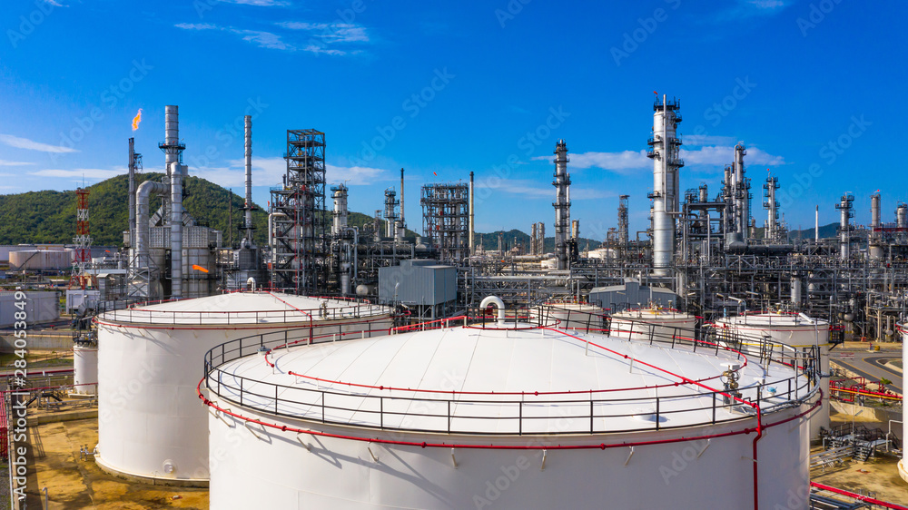 Oil refinery and petrochemical plant industrial working with fire and ...