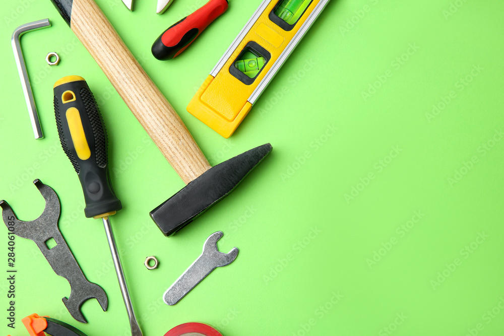 Set of repair tools on light green background, flat lay. Space for text ...