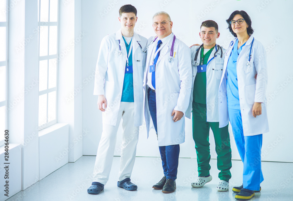 Successful medical team. Confident doctors team standing together and ... Successful medical team. Confident doctors team standing together and ...