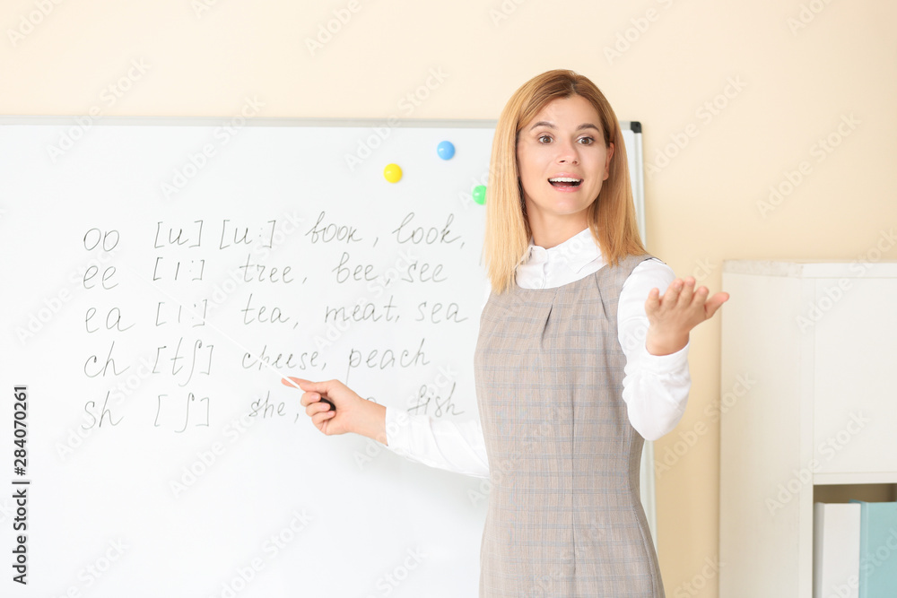 Beautiful English teacher calling out pupil during lesson in classroom ...