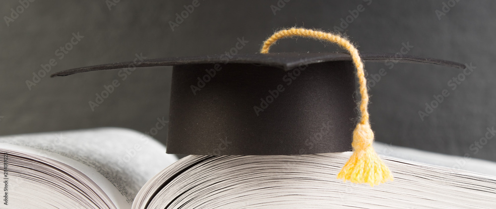 Open book on wooden deck table and black board background. Back to ...