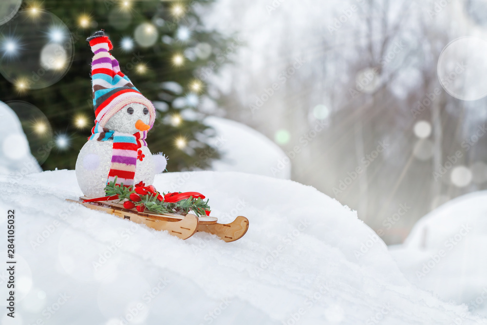 Snowman slides downhill on a sled - winter and Christmas fun concept ...