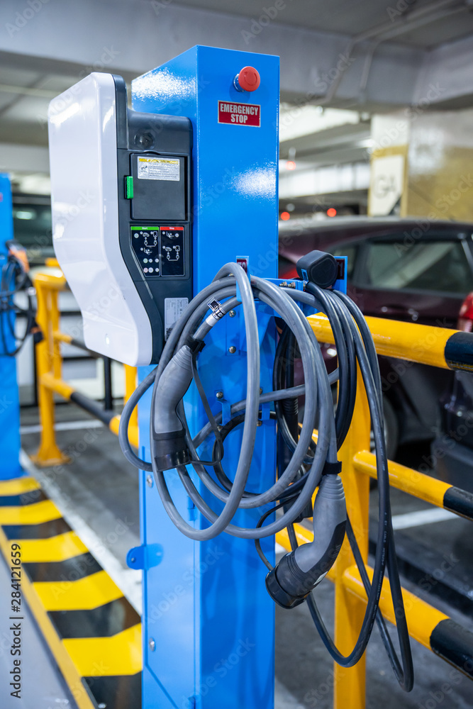 EV Car. Electric car. Charging Station with the power cable plugged in ...