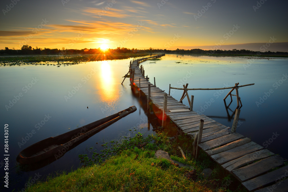 Old boats parked beside the old bridge architecture in the morning ...