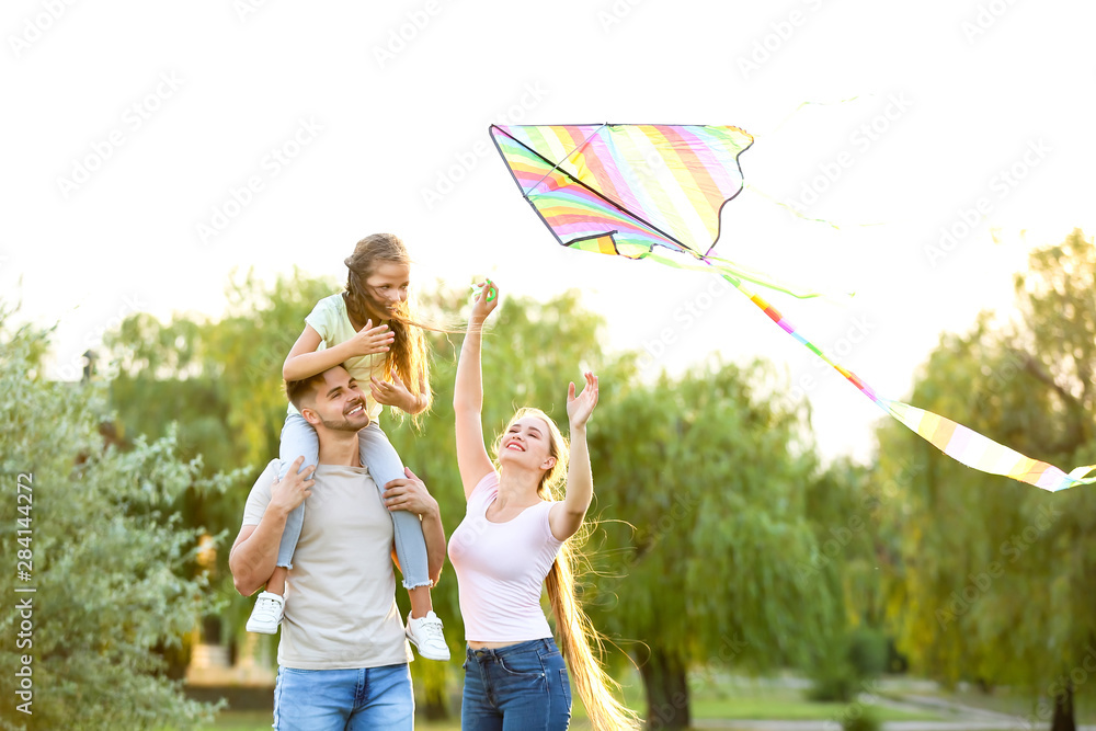 Happy family flying kite outdoors Stock Photo | Adobe Stock