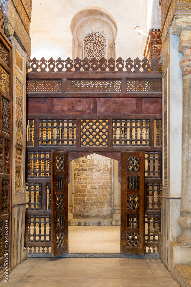 Interleaved wooden wall, known as mashrabiya, with wooden ornate door ...