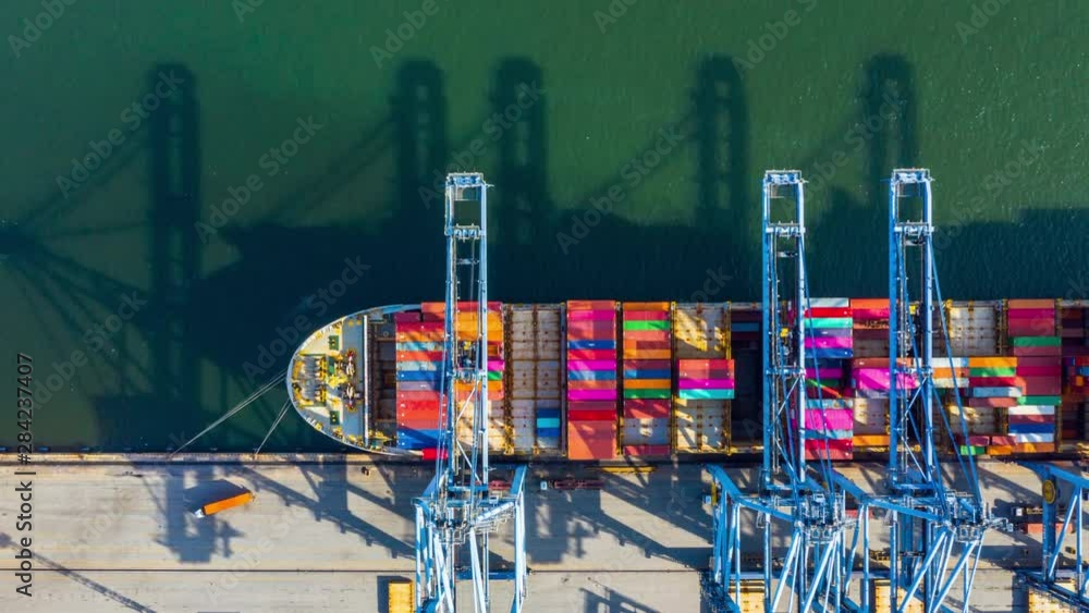 Container ship loading and unloading in deep sea port, Aerial top view ...