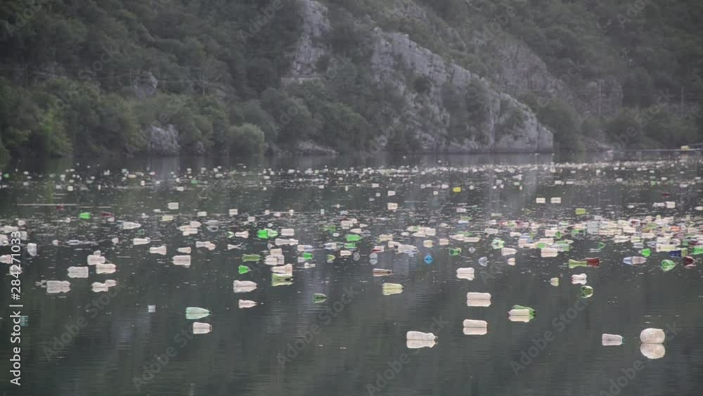 Plastic bags, bottles, garbage and trash dumped in river in nature ...