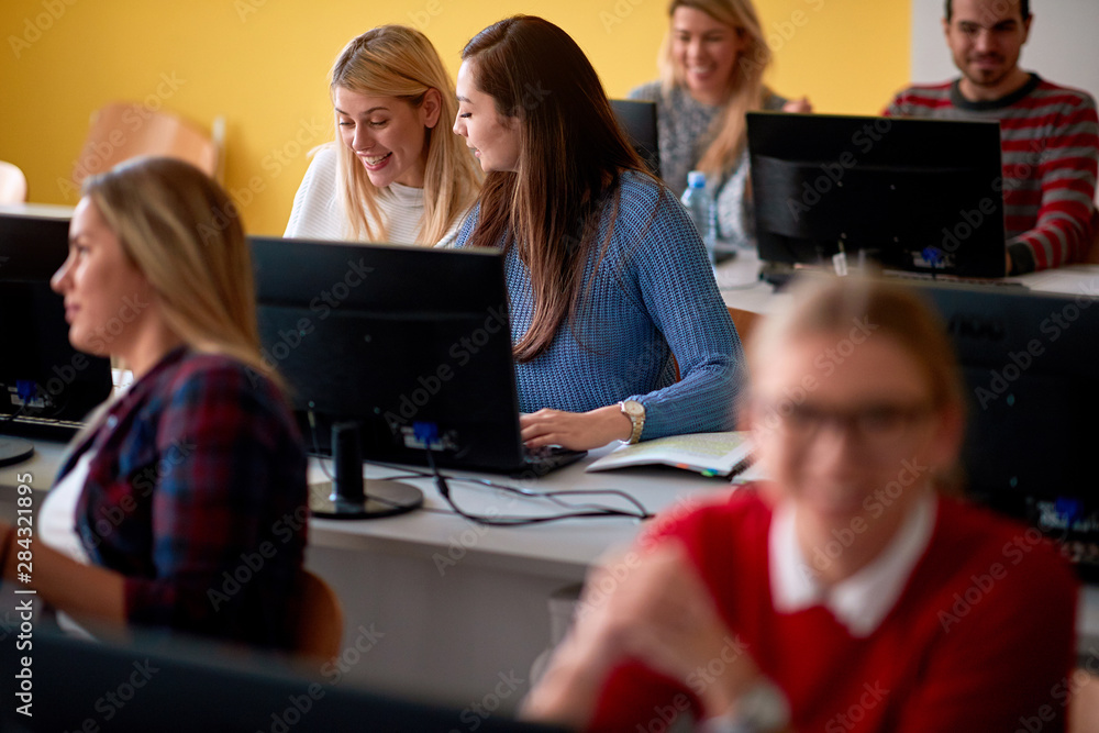 students having fun and smiling in lecture hall of modern college while ...