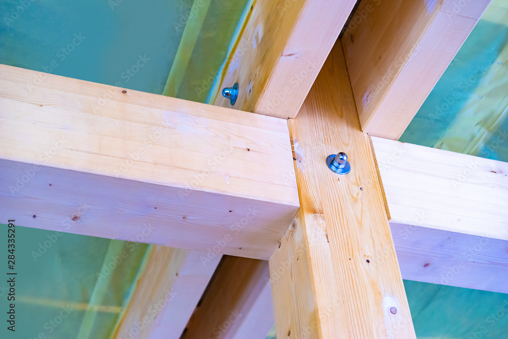 The wooden beam is connected by a bolt. Mounting the frame in the frame ...