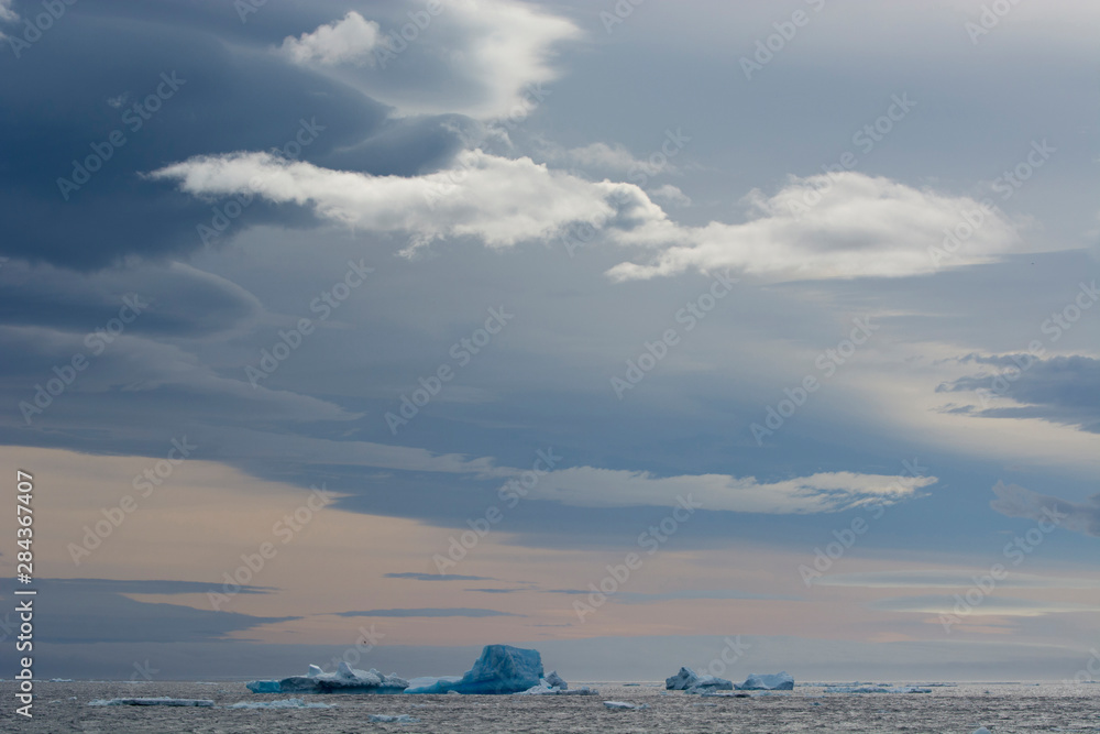 Antarctica. Brown Bluff. Lenticular clouds show katabatic winds are ...
