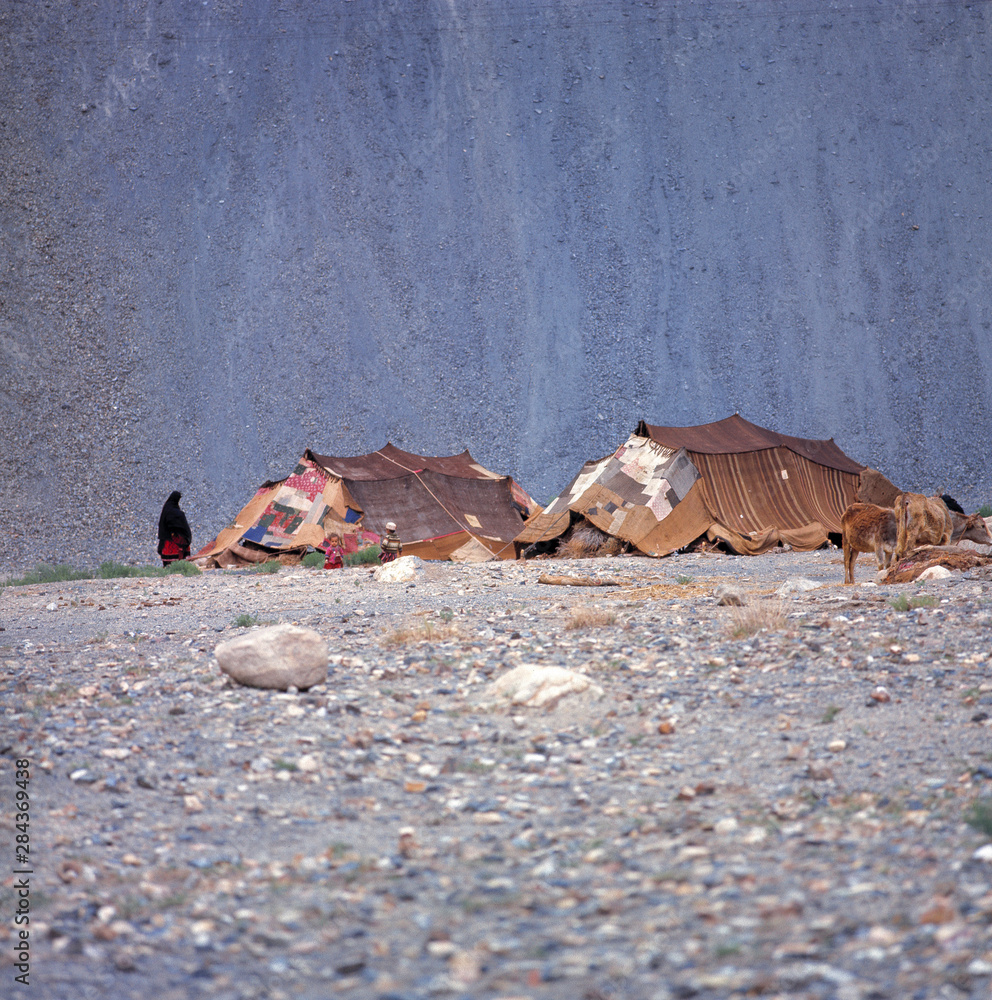 Afghanistan, Bamian Valley. Kuchi nomads pitch their tents on rough ...