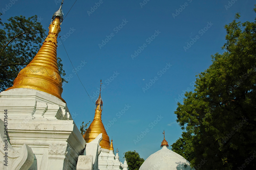 Myanmar, Mandalay, Small white buddhist temples and their golden ...