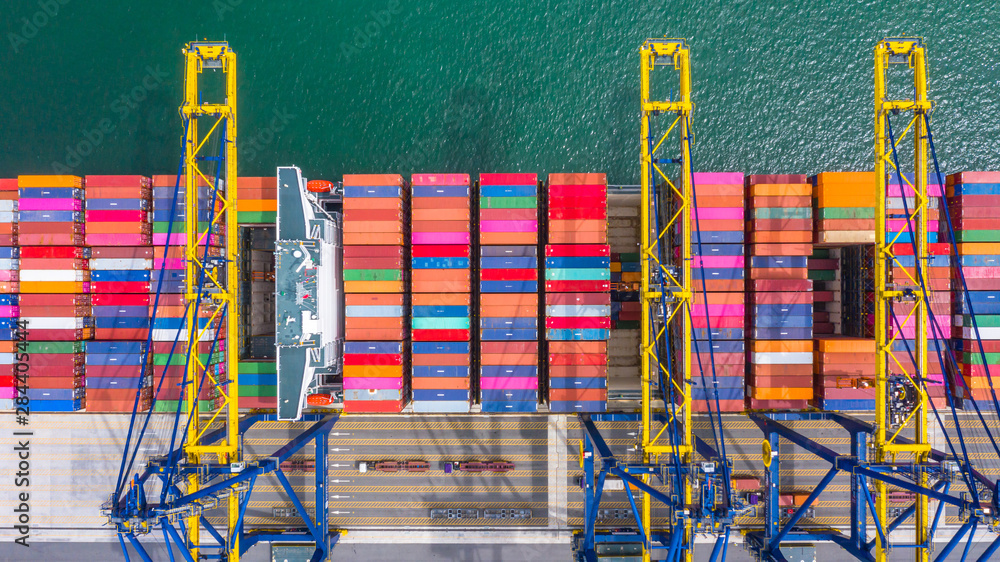 Container ship loading and unloading in deep sea port, Aerial top view ...