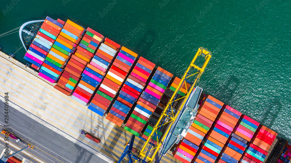Container ship loading and unloading in deep sea port, Aerial top view of business logistic ...
