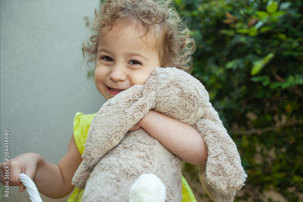 Cute little girl hugging her stuffed Easter Bunny plush toy Stock Photo ...