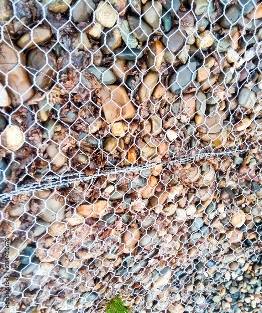 Retaining net on the slope. The net keeps the pebble from scattering ...