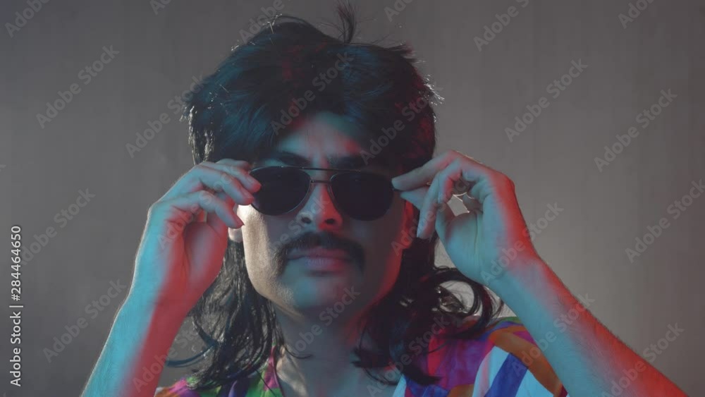 A man from the 70s 80s 90s with a mustache and a mullet hairstyle ...